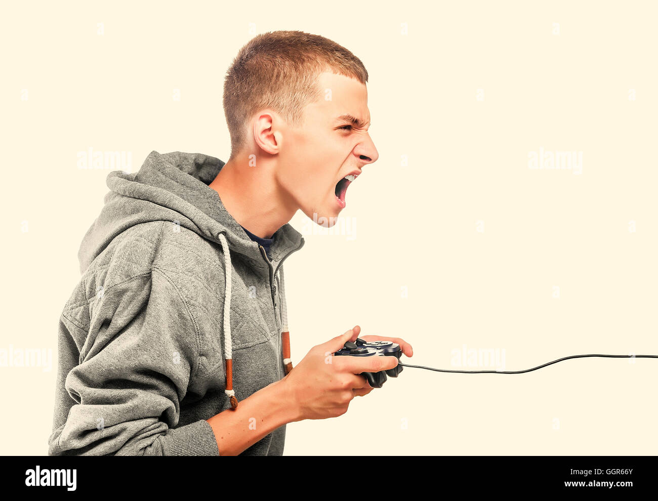 Young man with a joystick for game console side view. Toned photo Stock ...