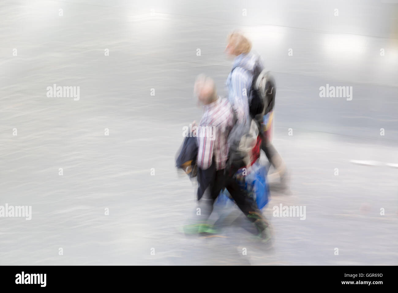 People stream in modern interior, motion blur Stock Photo - Alamy