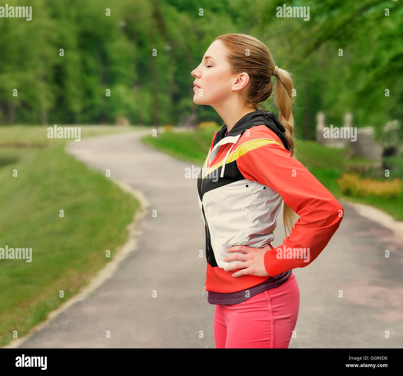 Woman relaxing after running. Fitness girl resting after training ...