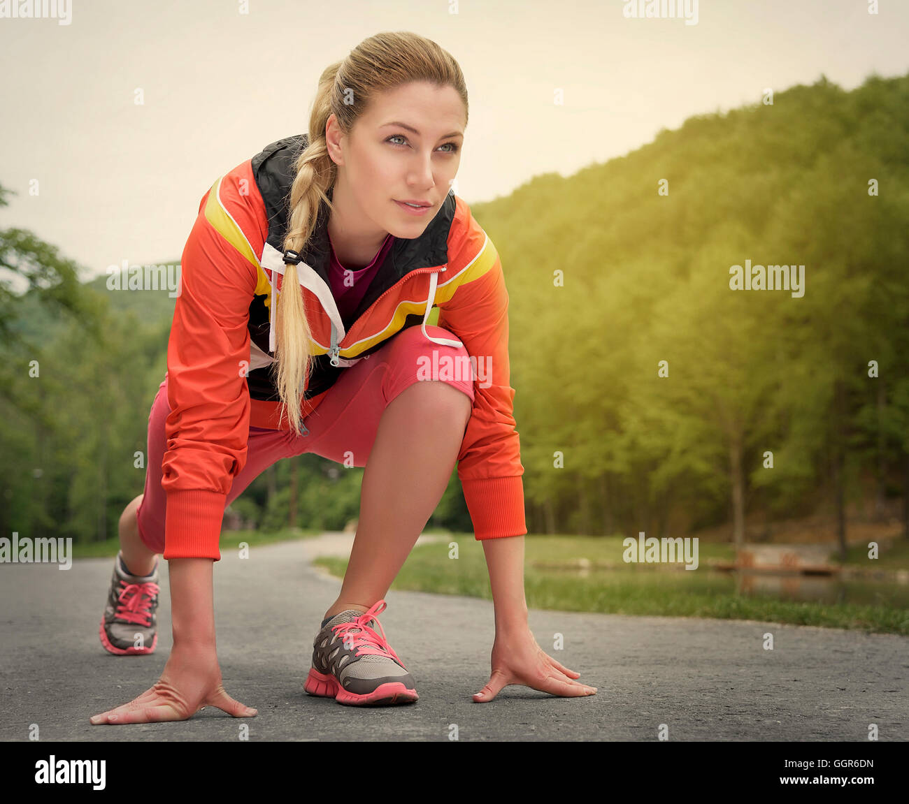 Attractive blonde woman running on track outdoors fitness, sport ...