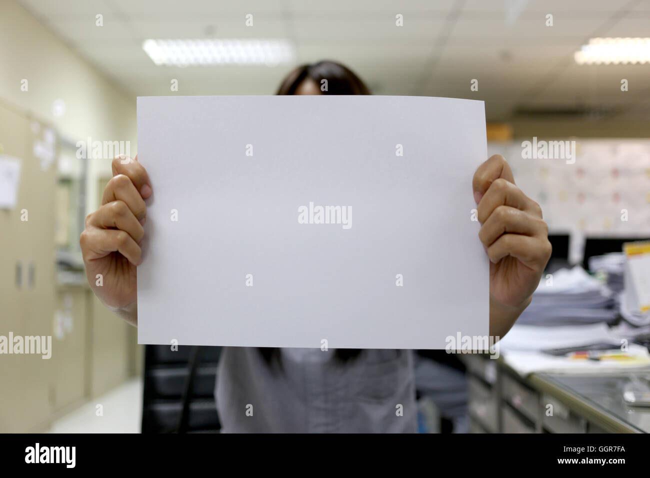 Woman's hand holding a blank white paper for input text to Design ...