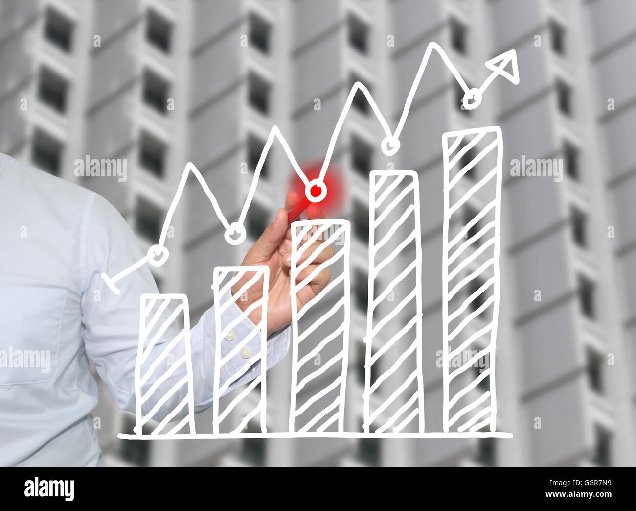 Hand of businessman drawing graphics in growing graph to concept of ...
