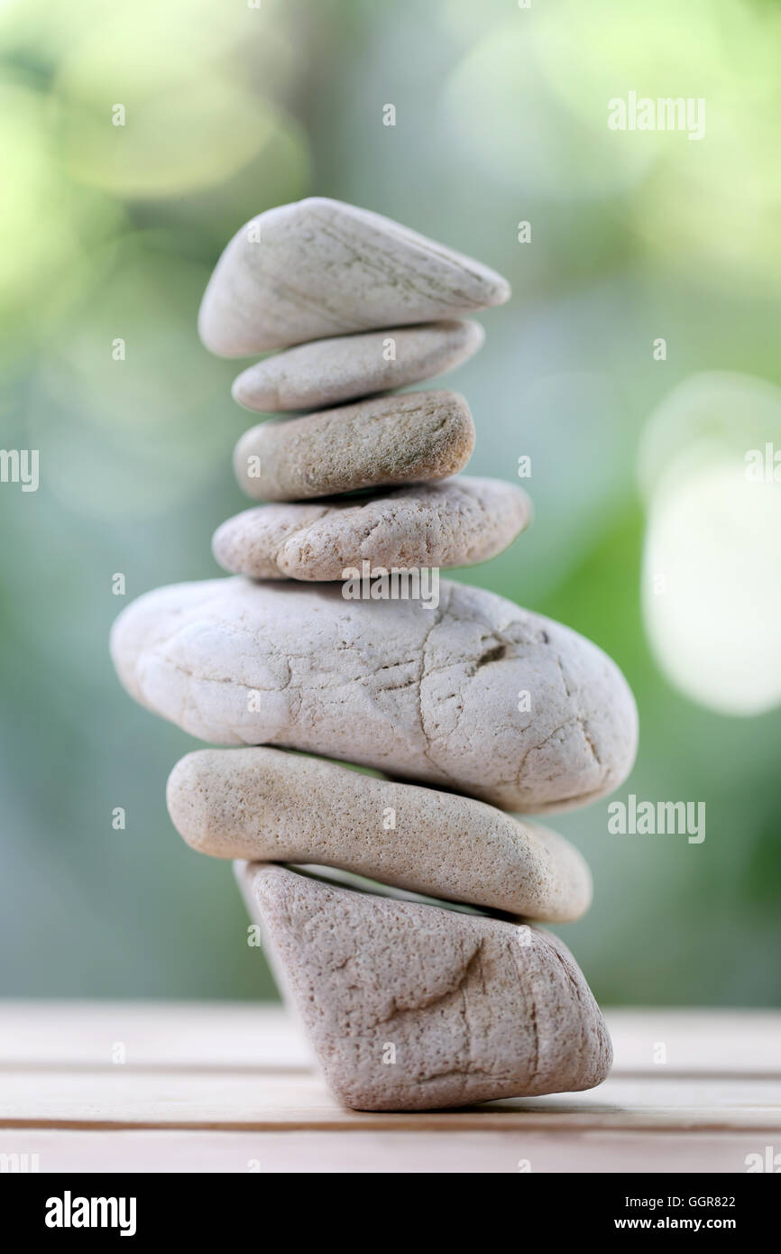 balance rock or zen stones on wooden floor and have nature green ...