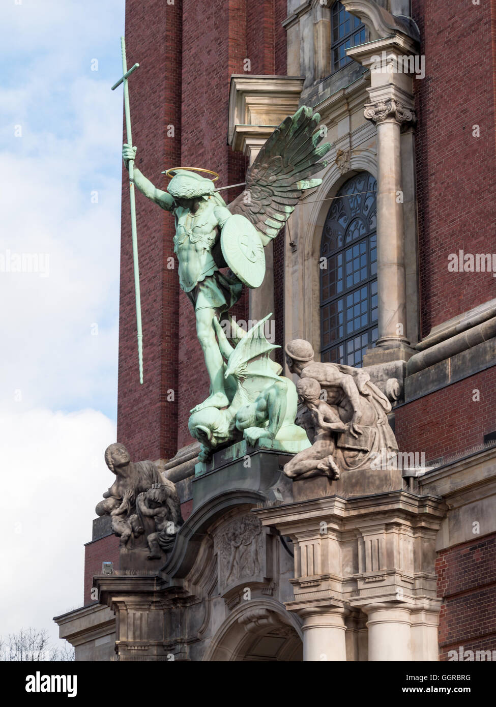 Angel and dragon sculpture above the entrance to St Michaels Church ...