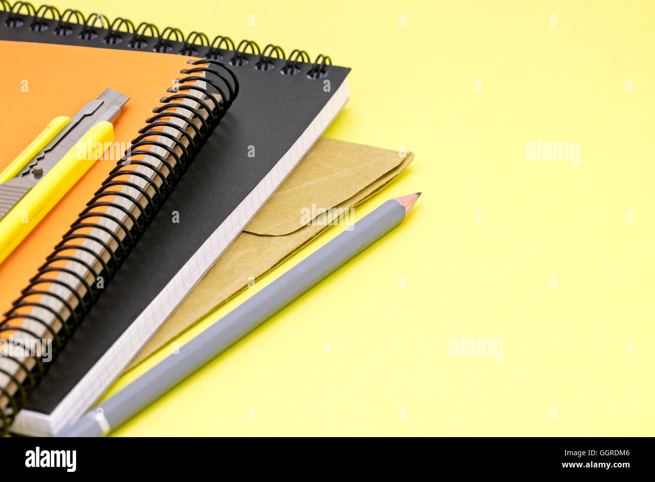 yellow writing desk background with colorful notebooks, pencil ...
