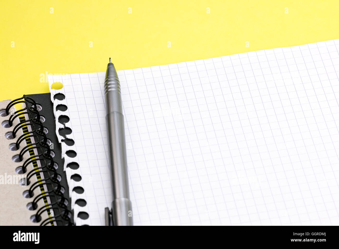 pencil, notepad and blank sheet of paper on yellow desk background ...