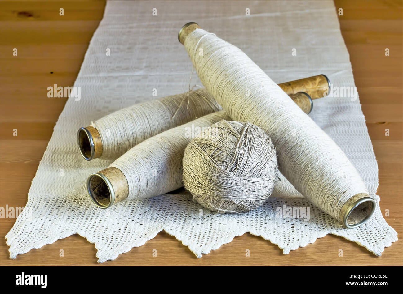 Vintage spools with natural linen threads and handmade lace tablecloth ...