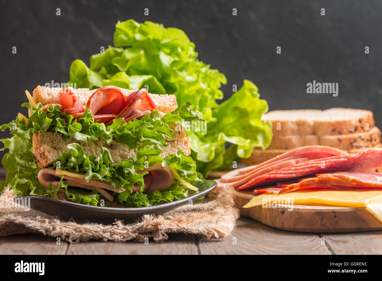 Club sandwich on a rustic table Stock Photo - Alamy
