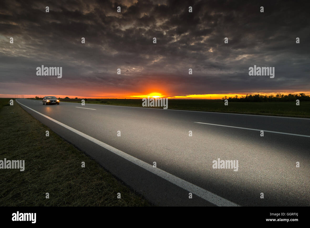 Car driving on freeway at sunset Stock Photo - Alamy