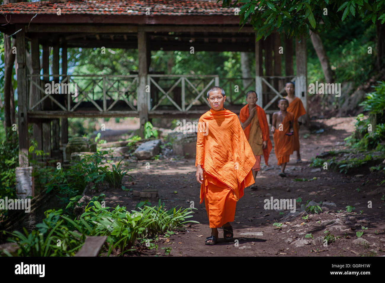 Young monk walking the path Stock Photo - Alamy