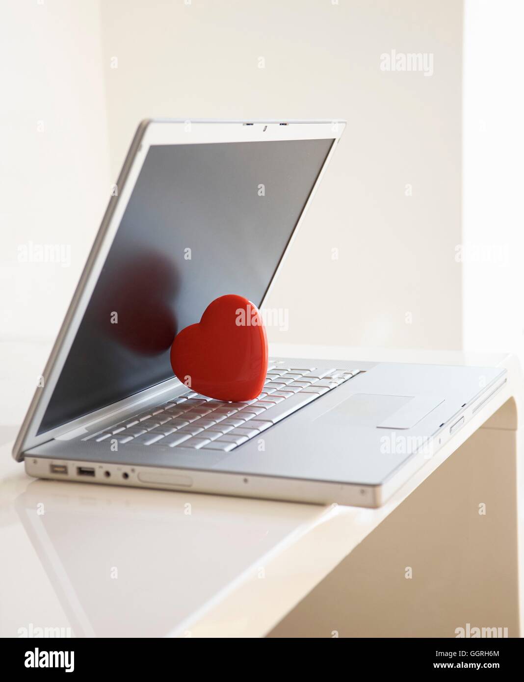 Red heart on laptop computer Stock Photo - Alamy