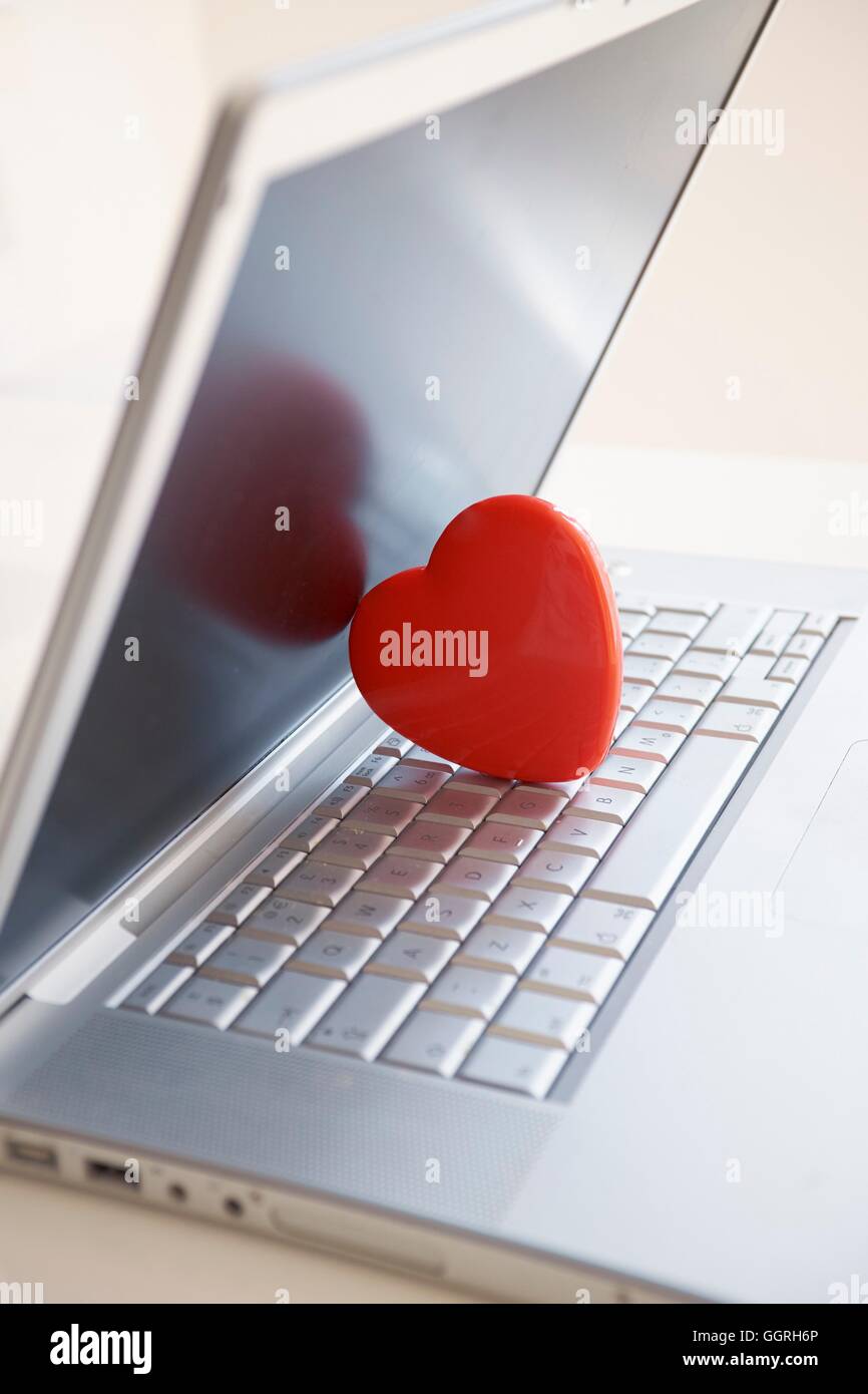 Red heart on laptop computer Stock Photo - Alamy