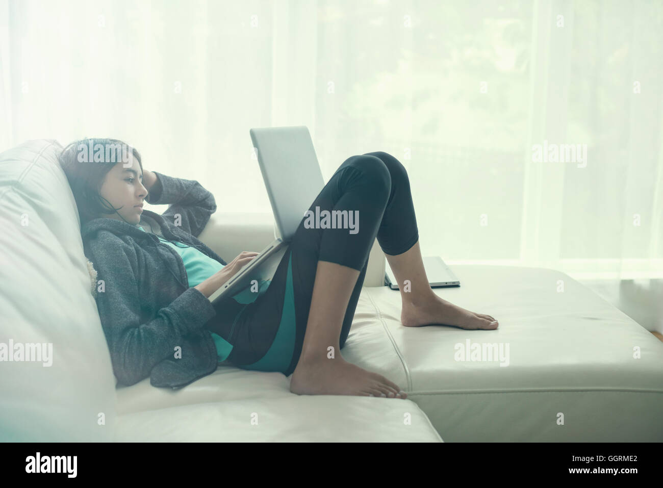 Barefoot girl laptop hi-res stock photography and images - Alamy