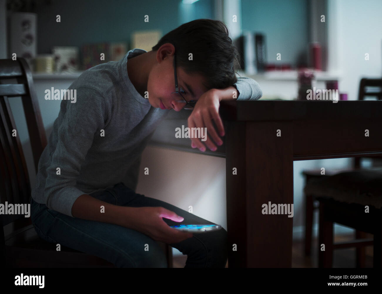 Mixed Race boy using cell phone at night Stock Photo - Alamy