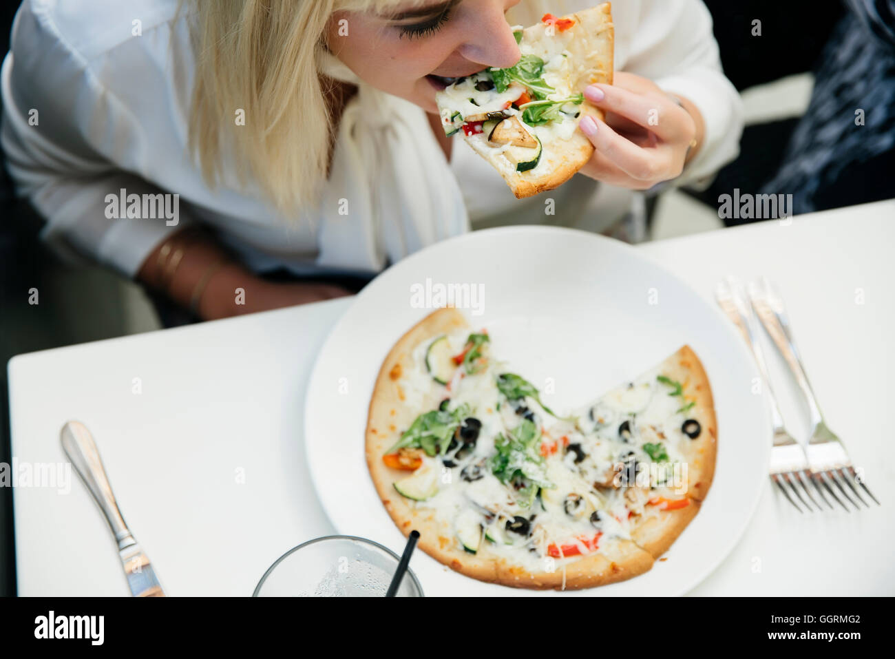 Blonde eating pizza woman hi-res stock photography and images - Alamy