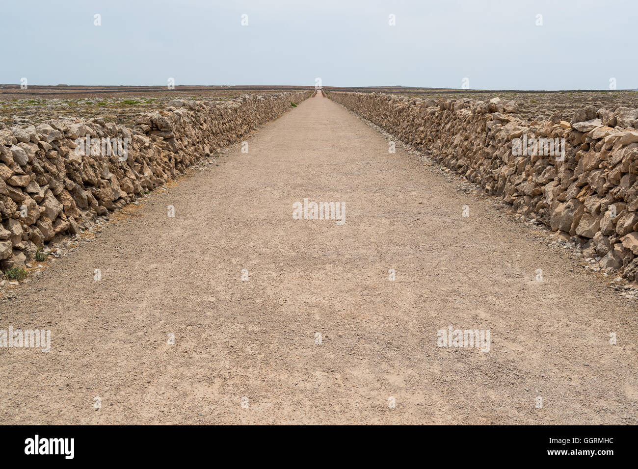 Path between stone walls Stock Photo - Alamy