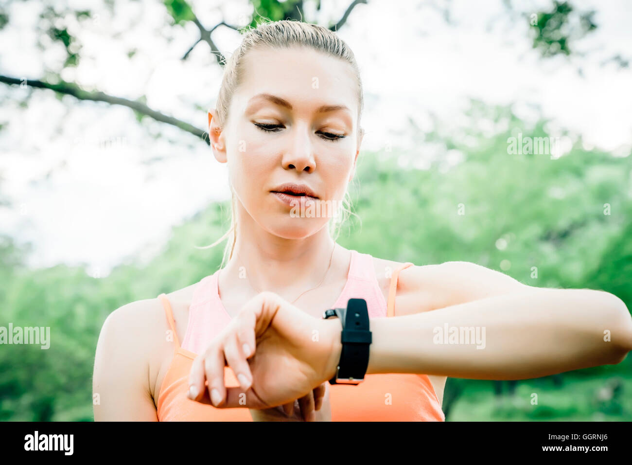 Caucasian woman checking the time on wristwatch outdoors Stock Photo ...