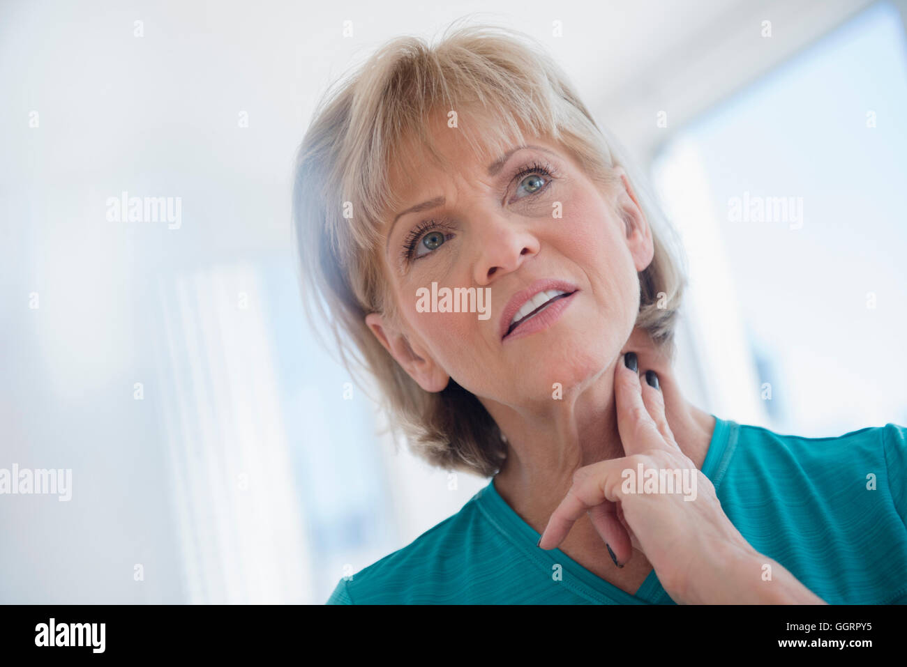 Older Caucasian woman checking pulse on neck Stock Photo - Alamy