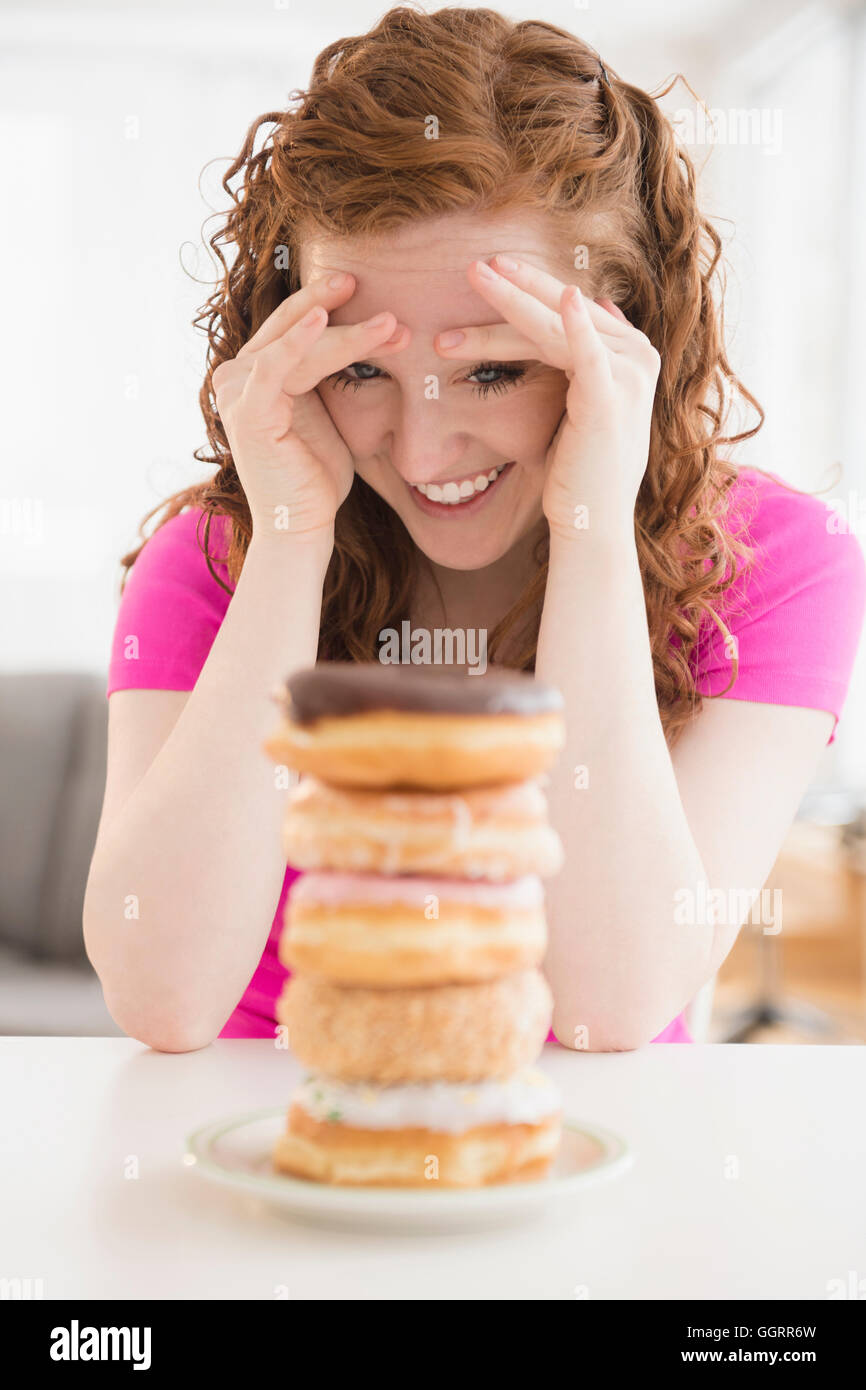 Woman donuts food pile hi-res stock photography and images - Alamy
