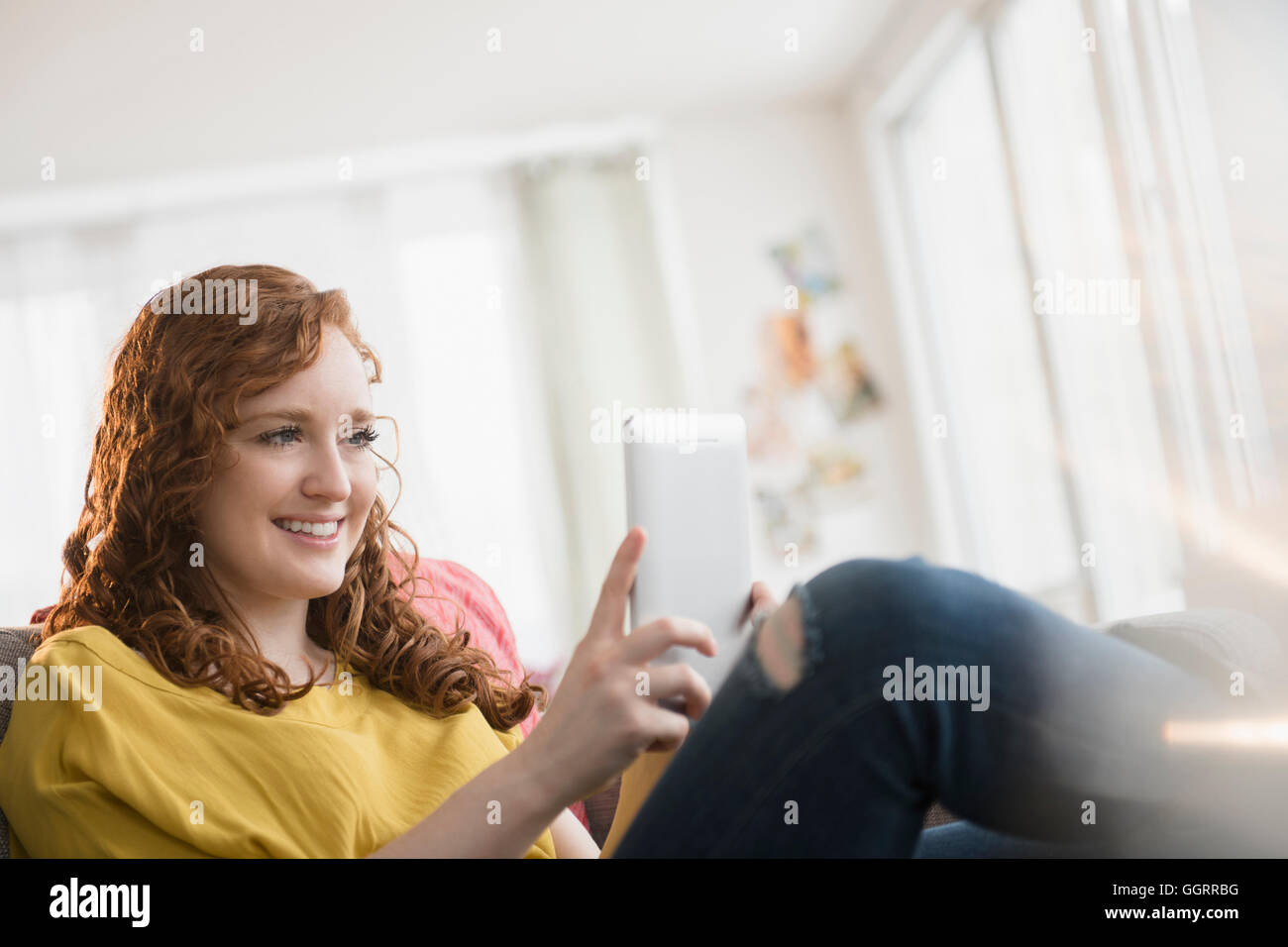 Woman smiling using digital hi-res stock photography and images - Alamy