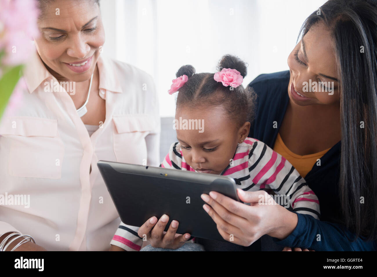 Black multi-generation family using digital tablet Stock Photo - Alamy