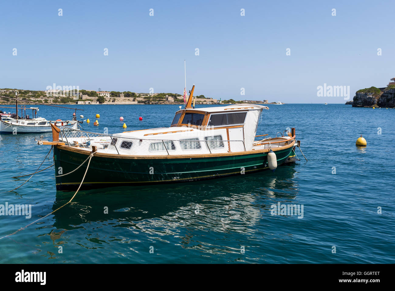 Small wooden boat floating on the sea Stock Photo - Alamy