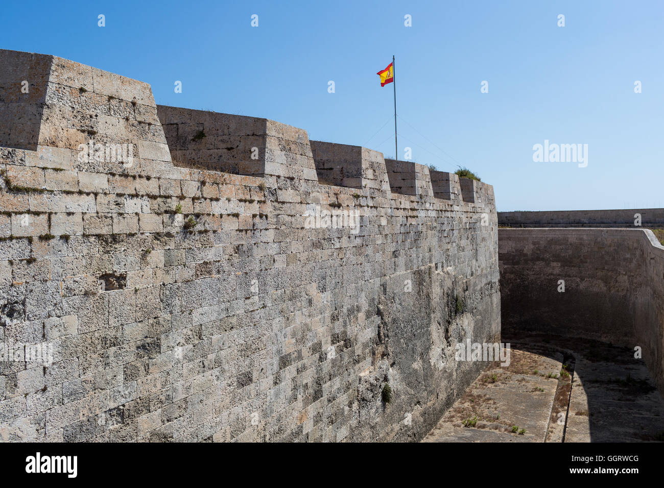 Mediterranean fort wall with its flag Stock Photo - Alamy