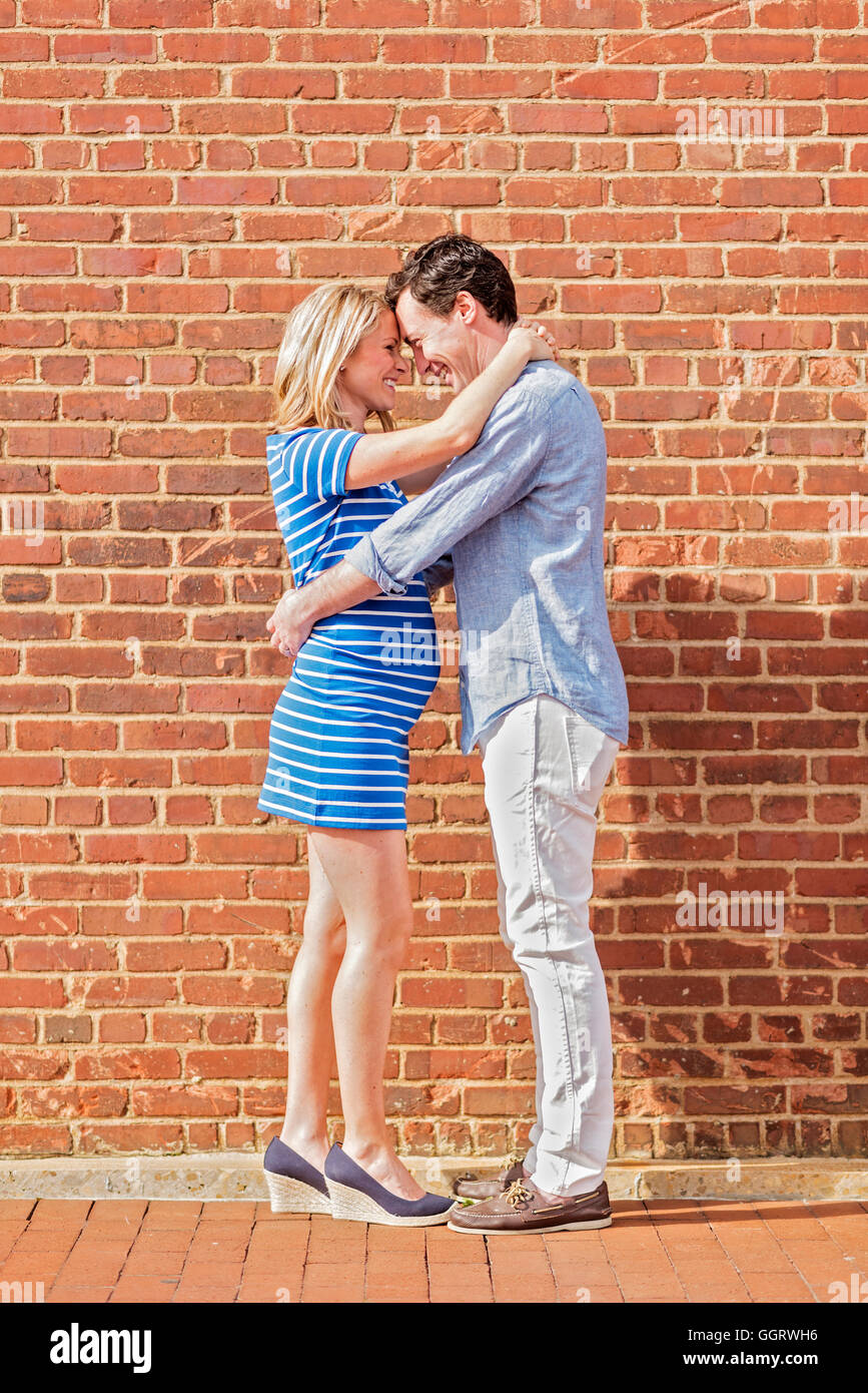 Couple standing near red brick hi-res stock photography and images - Alamy