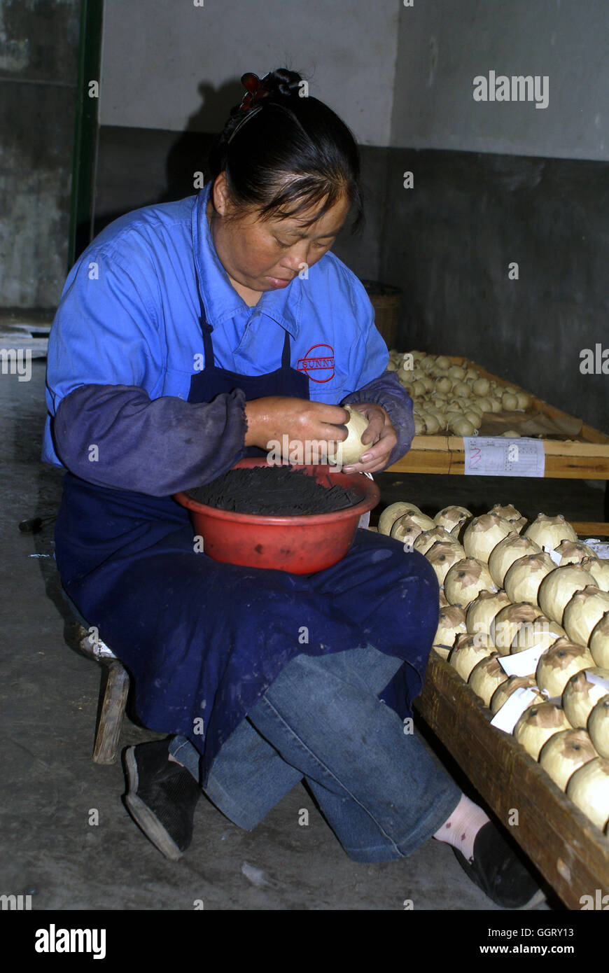 Workers assembling three inch shells at the Sunny International ...