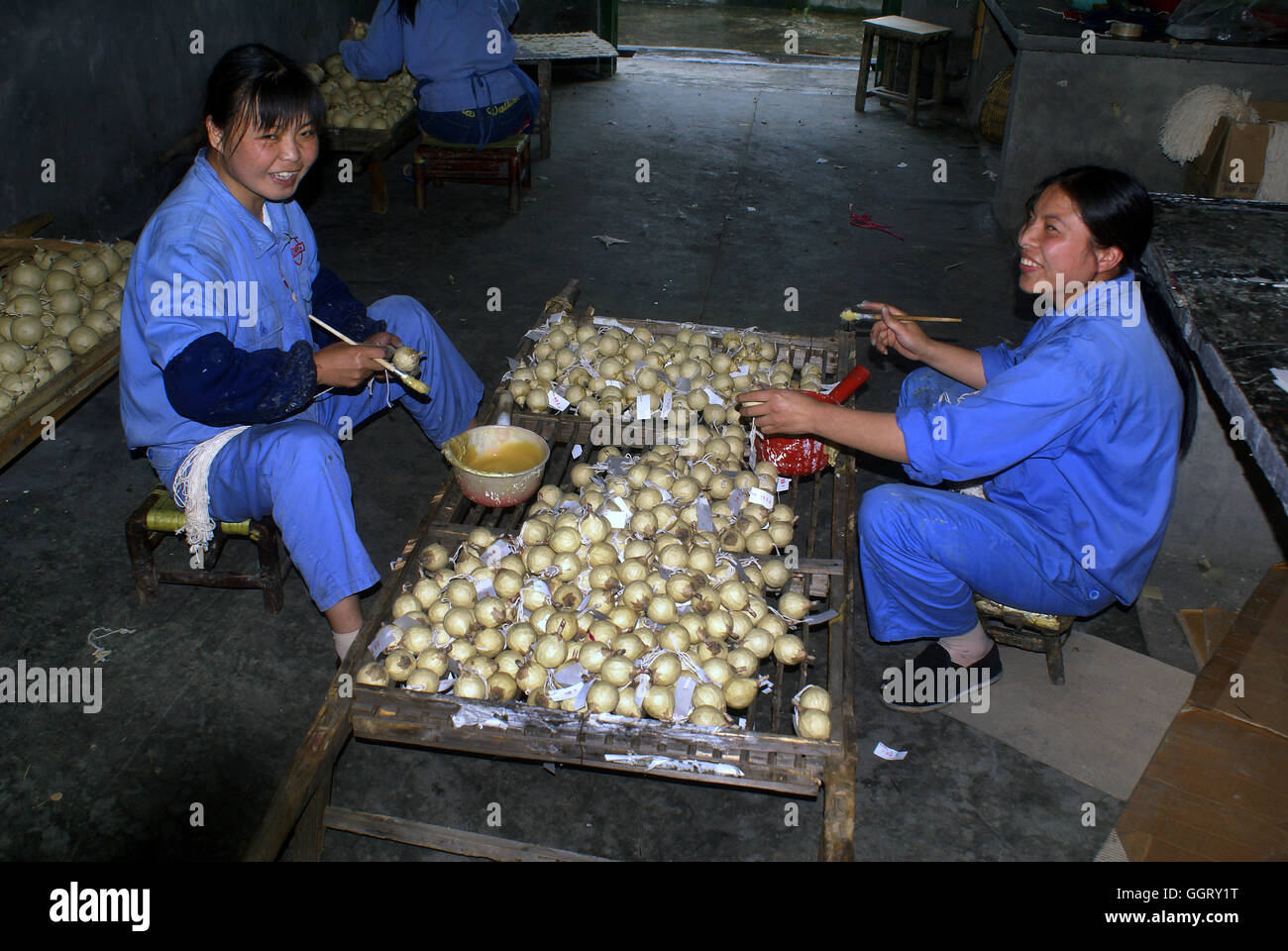 Workers assembling three inch shells at the Sunny International ...