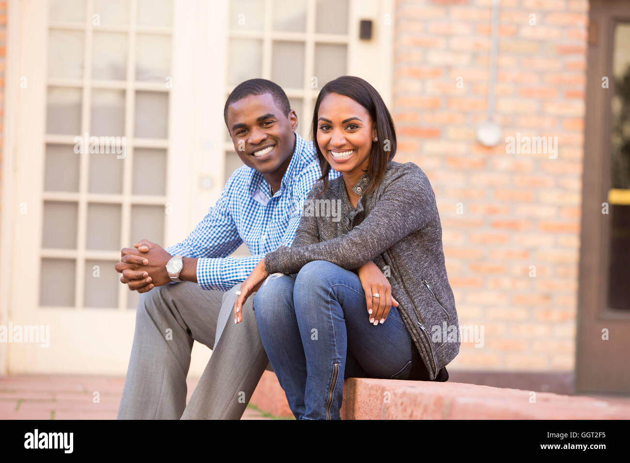 Two women sitting on stairs hi-res stock photography and images - Alamy