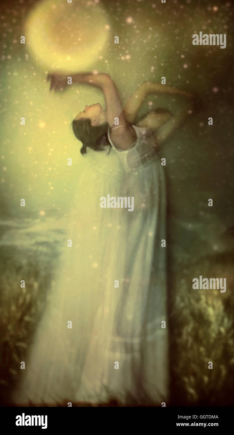 young woman wearing white long dress dancing with the full moon Stock ...