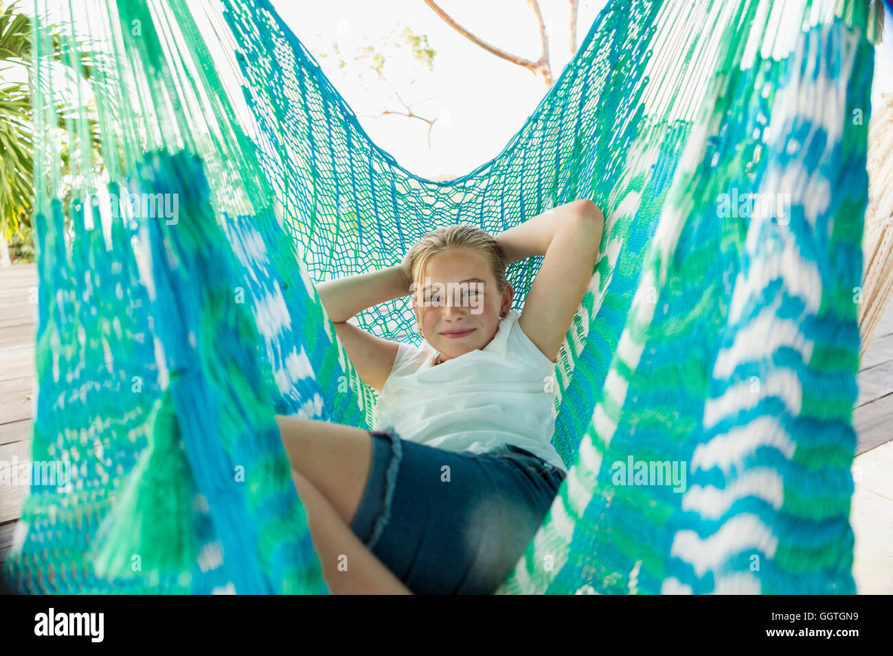 Caucasian girl laying in hammock Stock Photo - Alamy