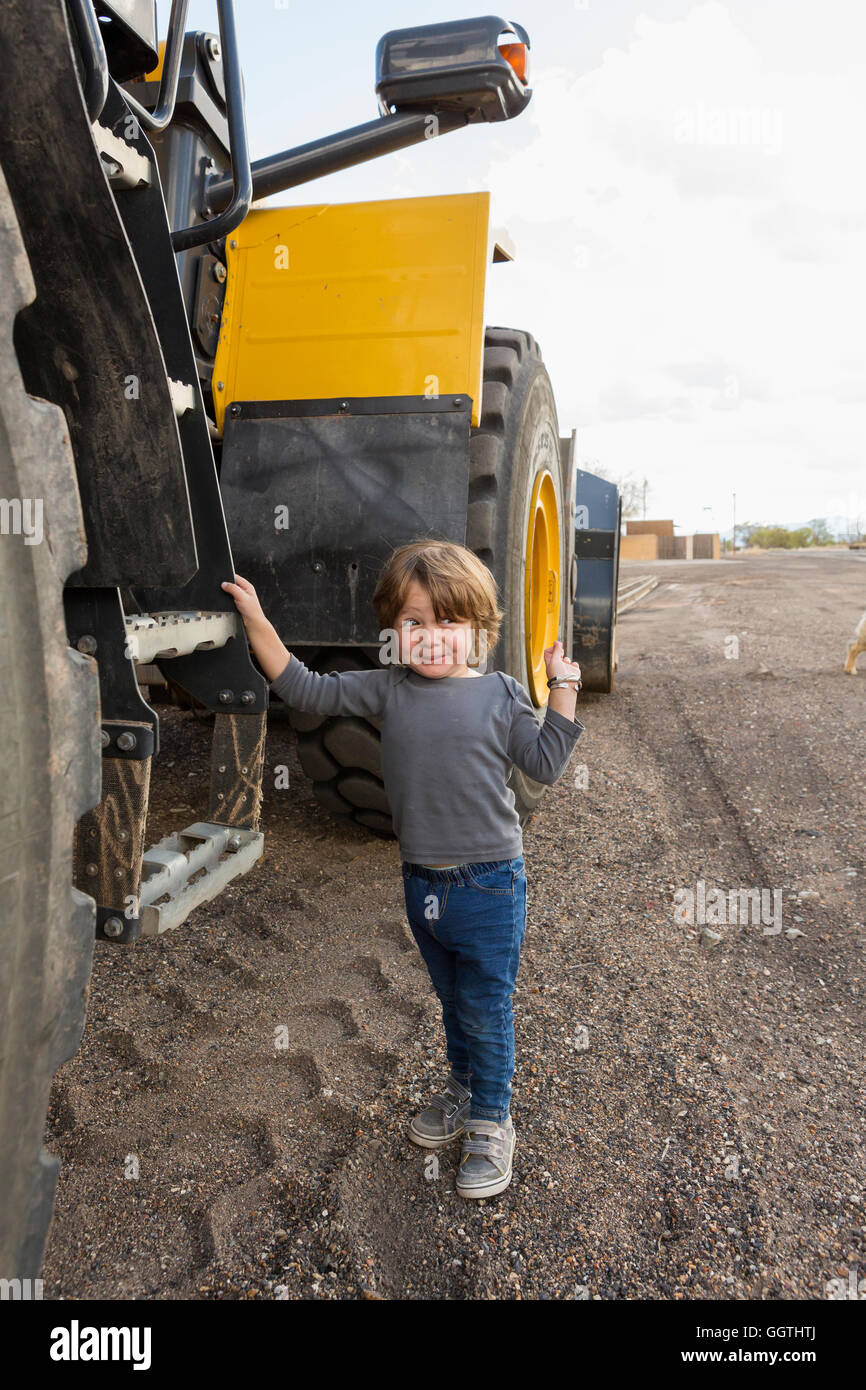 Caucasian boy holding ladder on tractor Stock Photo - Alamy