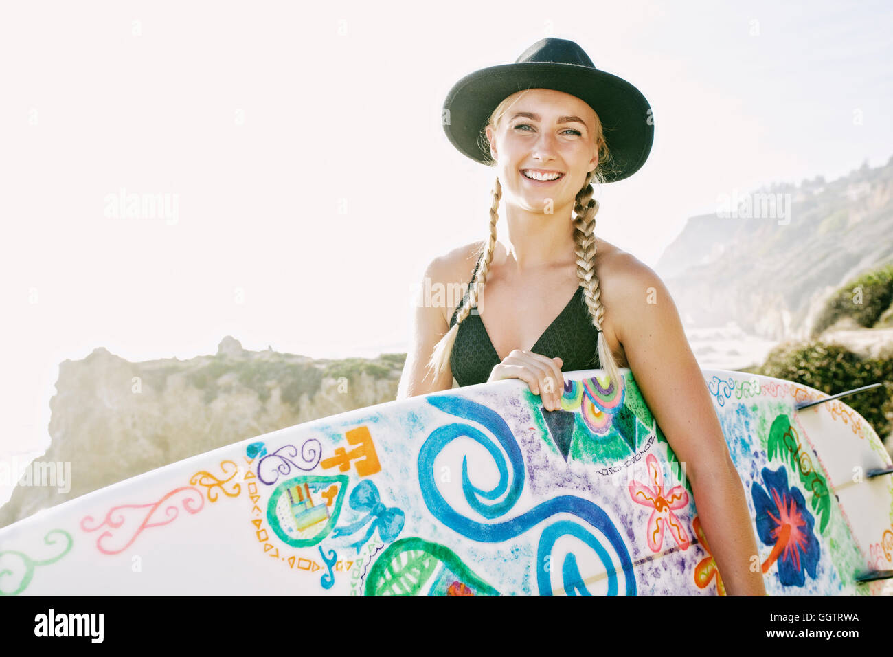 Caucasian woman carrying surfboard at beach Stock Photo - Alamy
