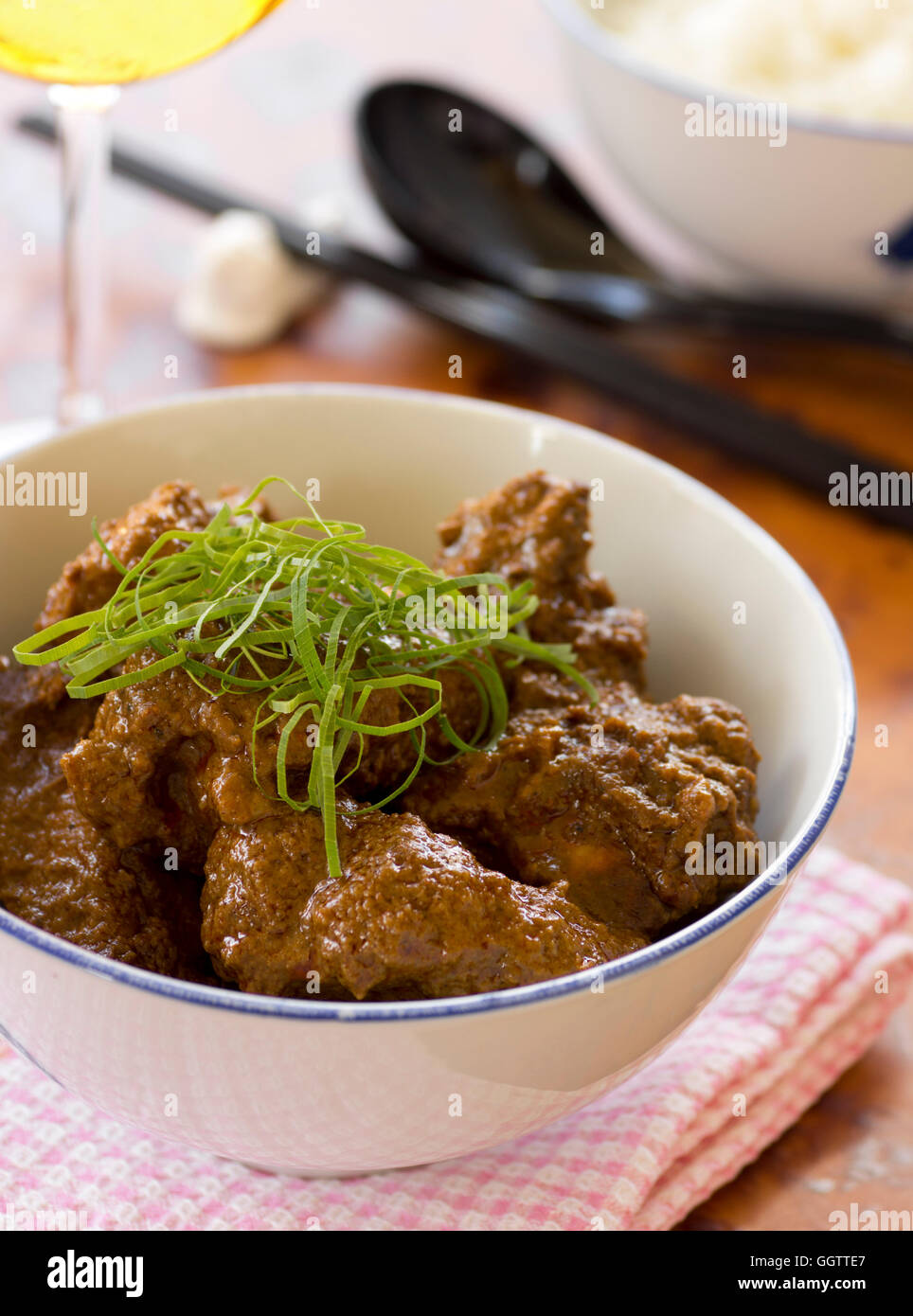 Chinese Styled Pork Rendang w steamed white rice and wine in background ...