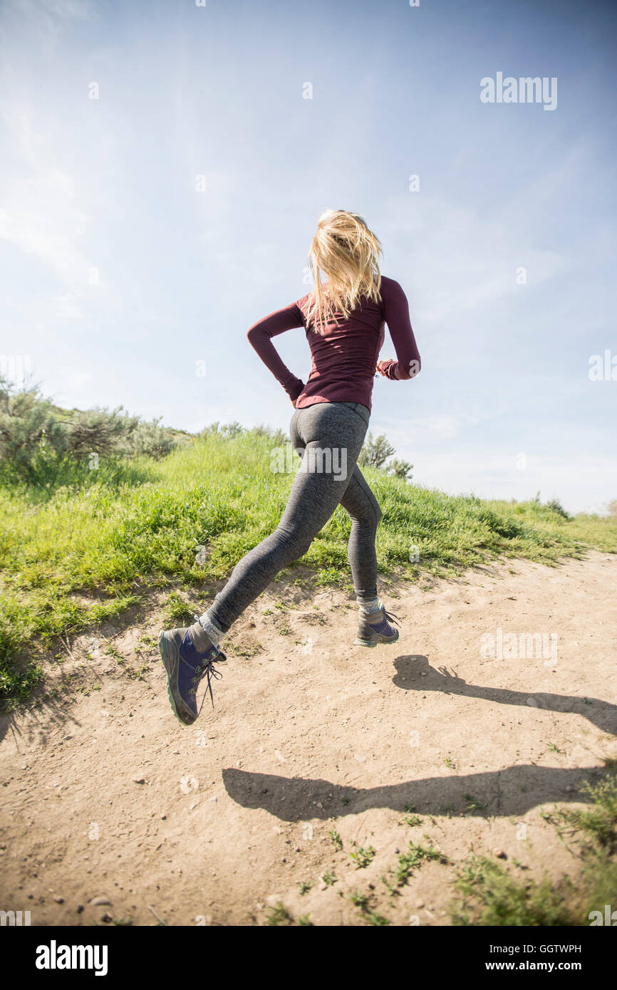 Caucasian woman running on dirt path Stock Photo - Alamy