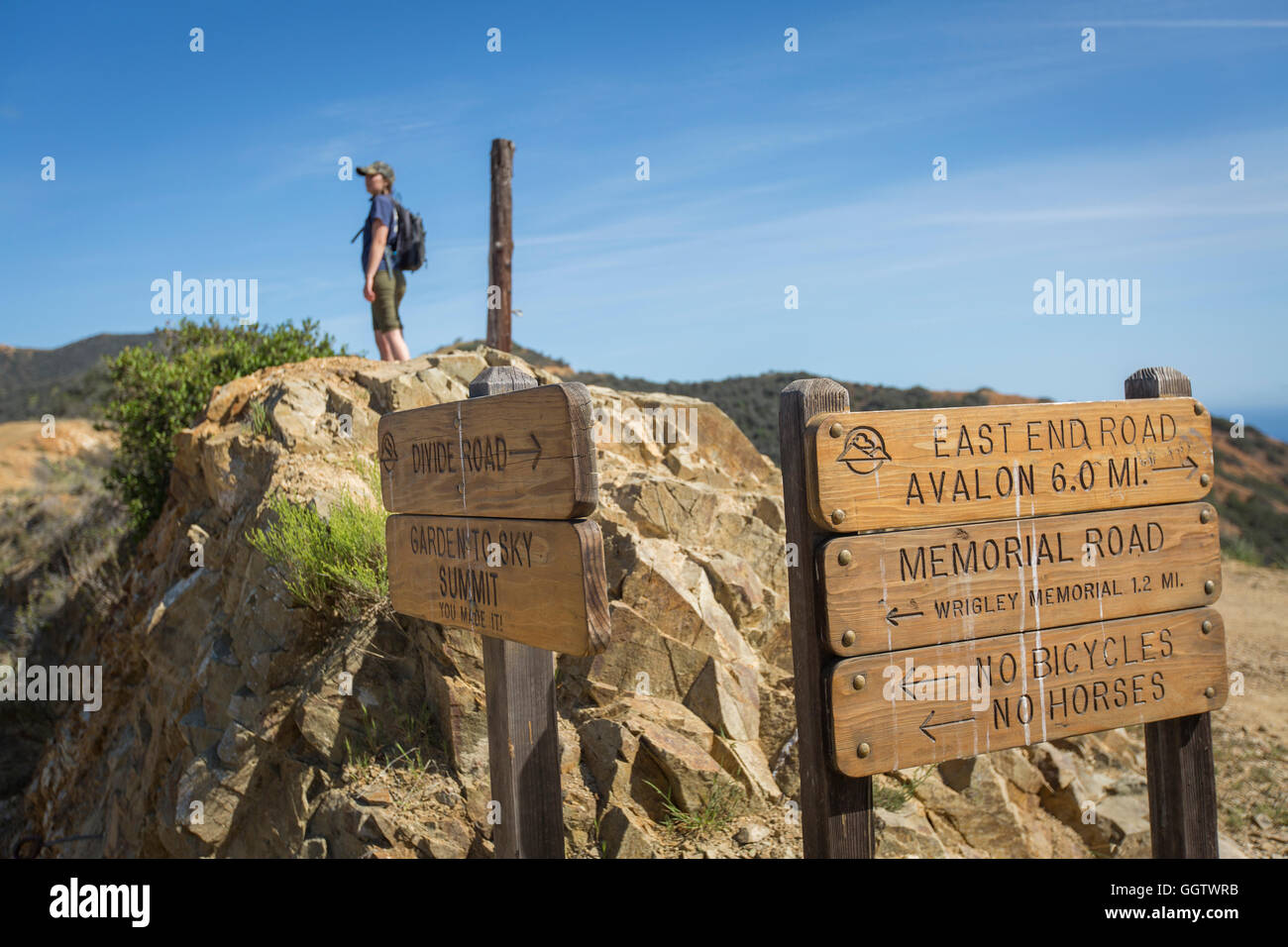 Caucasian hiker standing on rocks behind signs Stock Photo - Alamy