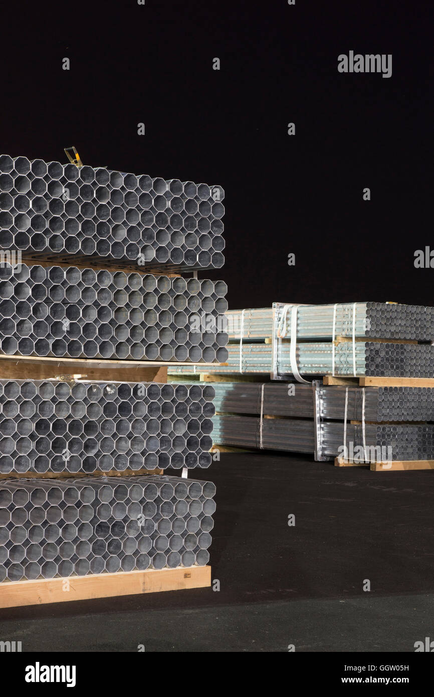 Pipes on pallets at night Stock Photo - Alamy