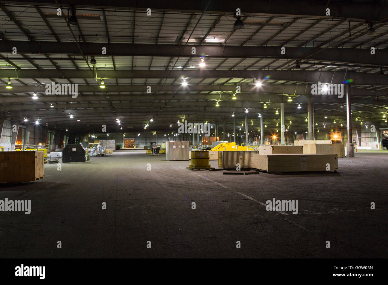 Pallets and containers in warehouse Stock Photo - Alamy