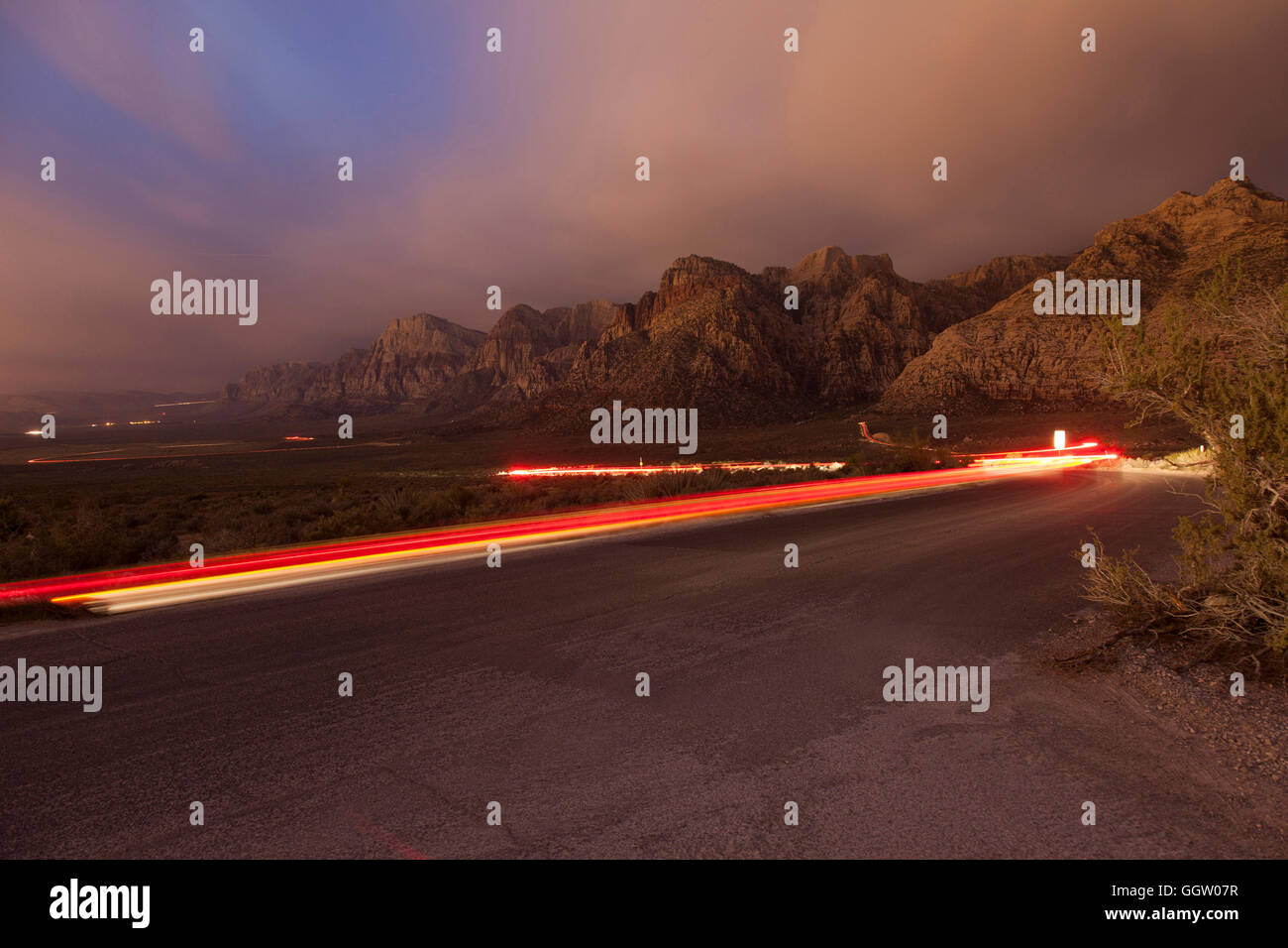 Curving light trails on street near mountain Stock Photo - Alamy