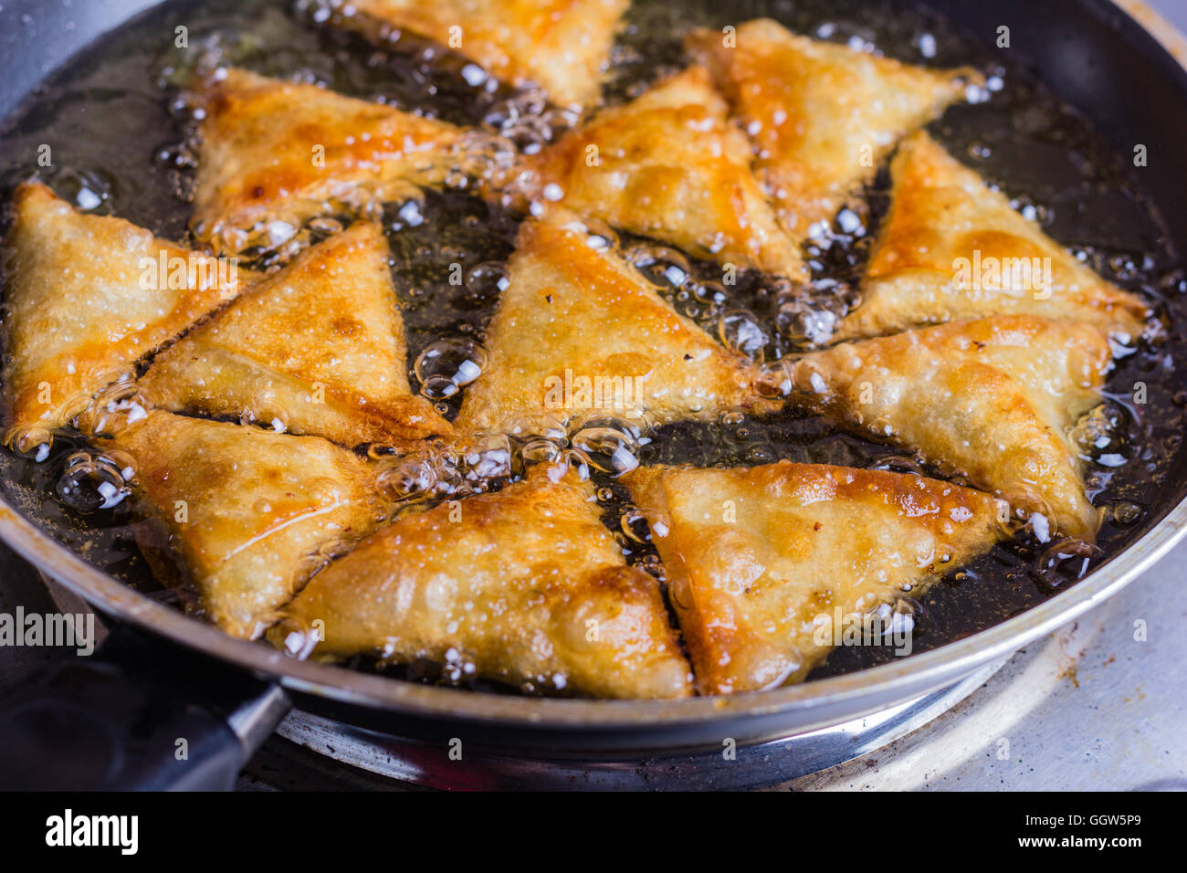 Deep fried golden brown and crispy chicken samosas Stock Photo - Alamy