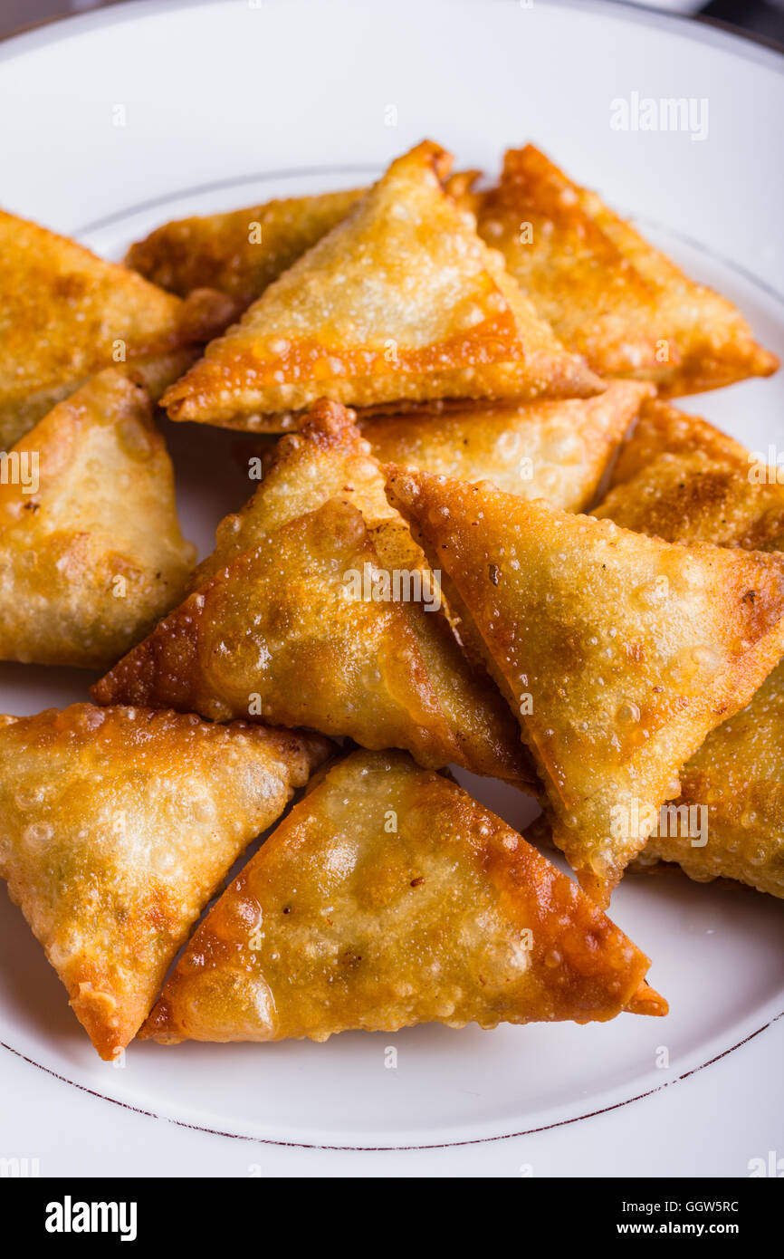 Deep fried golen brown and crispy chicken samosas Stock Photo - Alamy