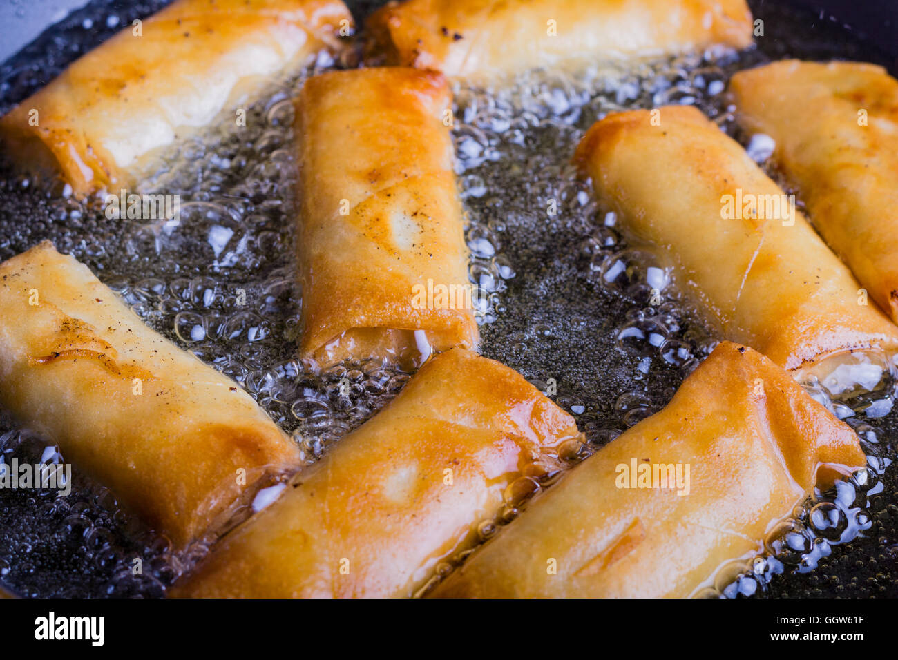 Frozen spring rolls with prawns being fried Stock Photo - Alamy