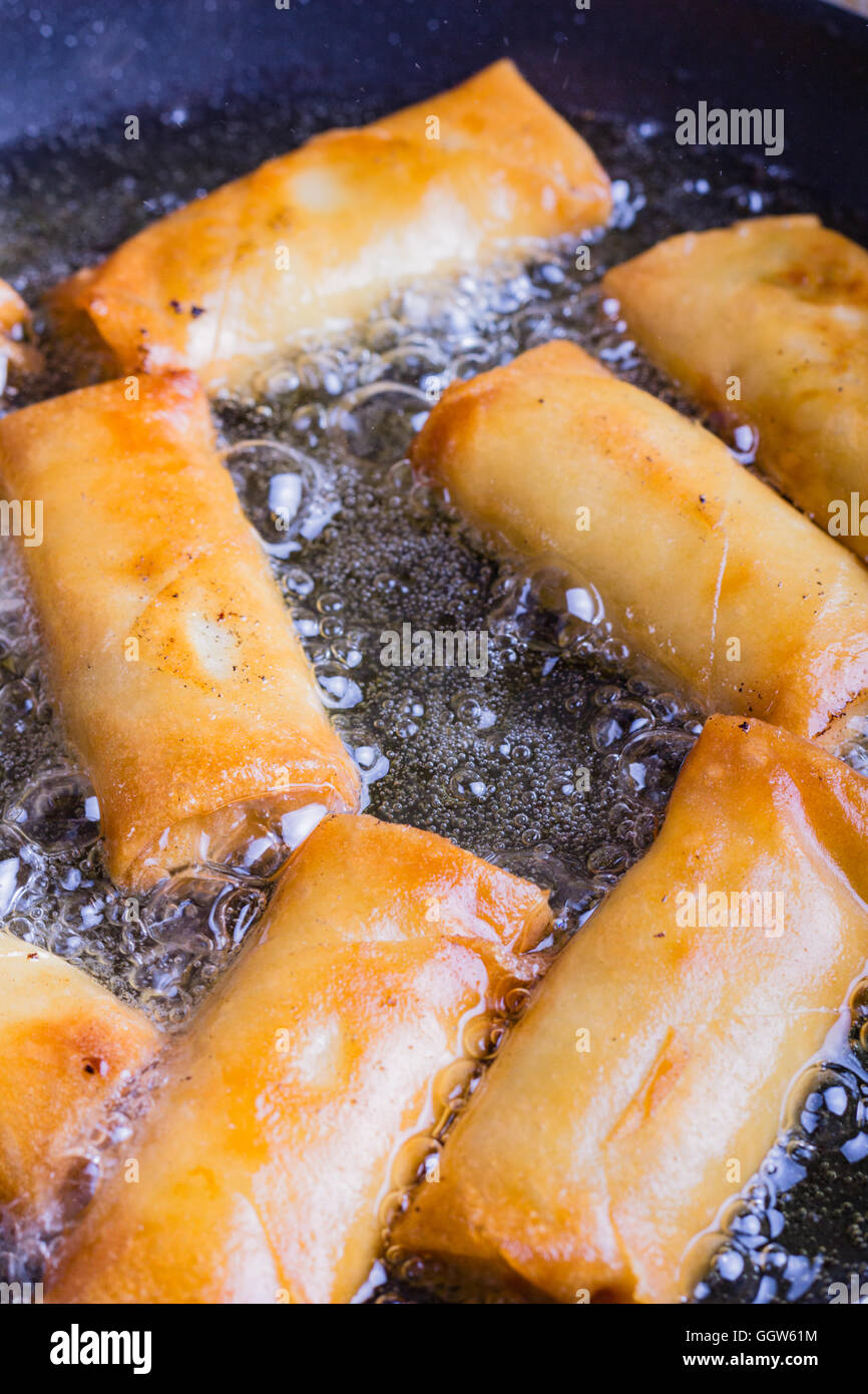 Frozen spring rolls with prawns being fried Stock Photo - Alamy