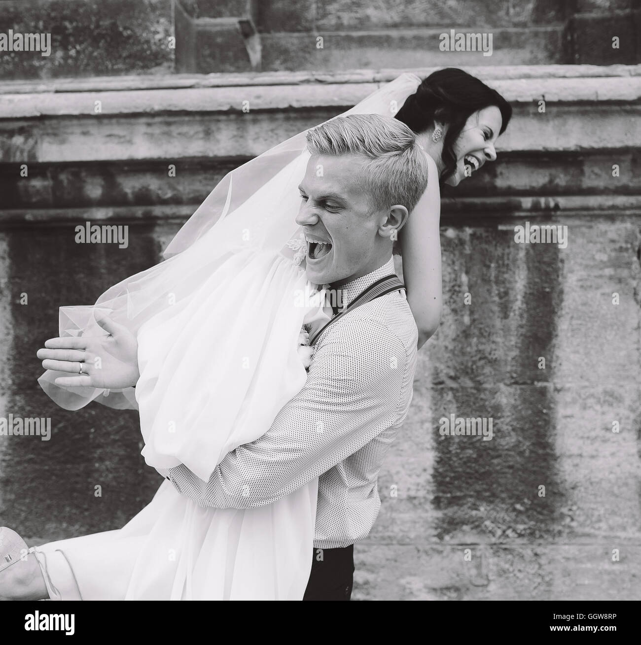 Bride carries groom hi-res stock photography and images - Alamy