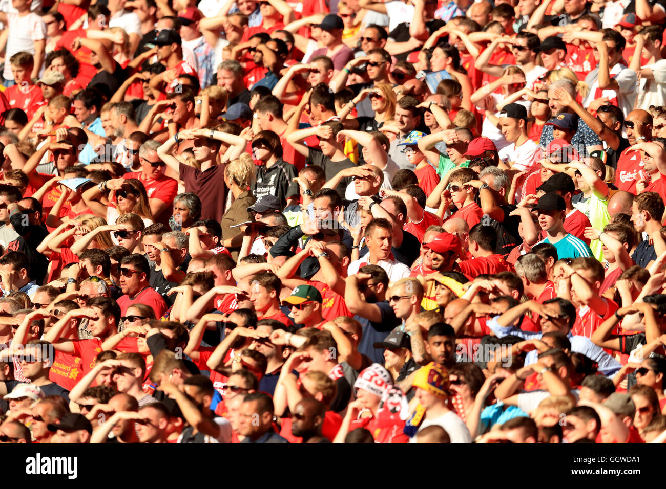 Fans shield their eyes from the sun in the stands during the pre-season ...