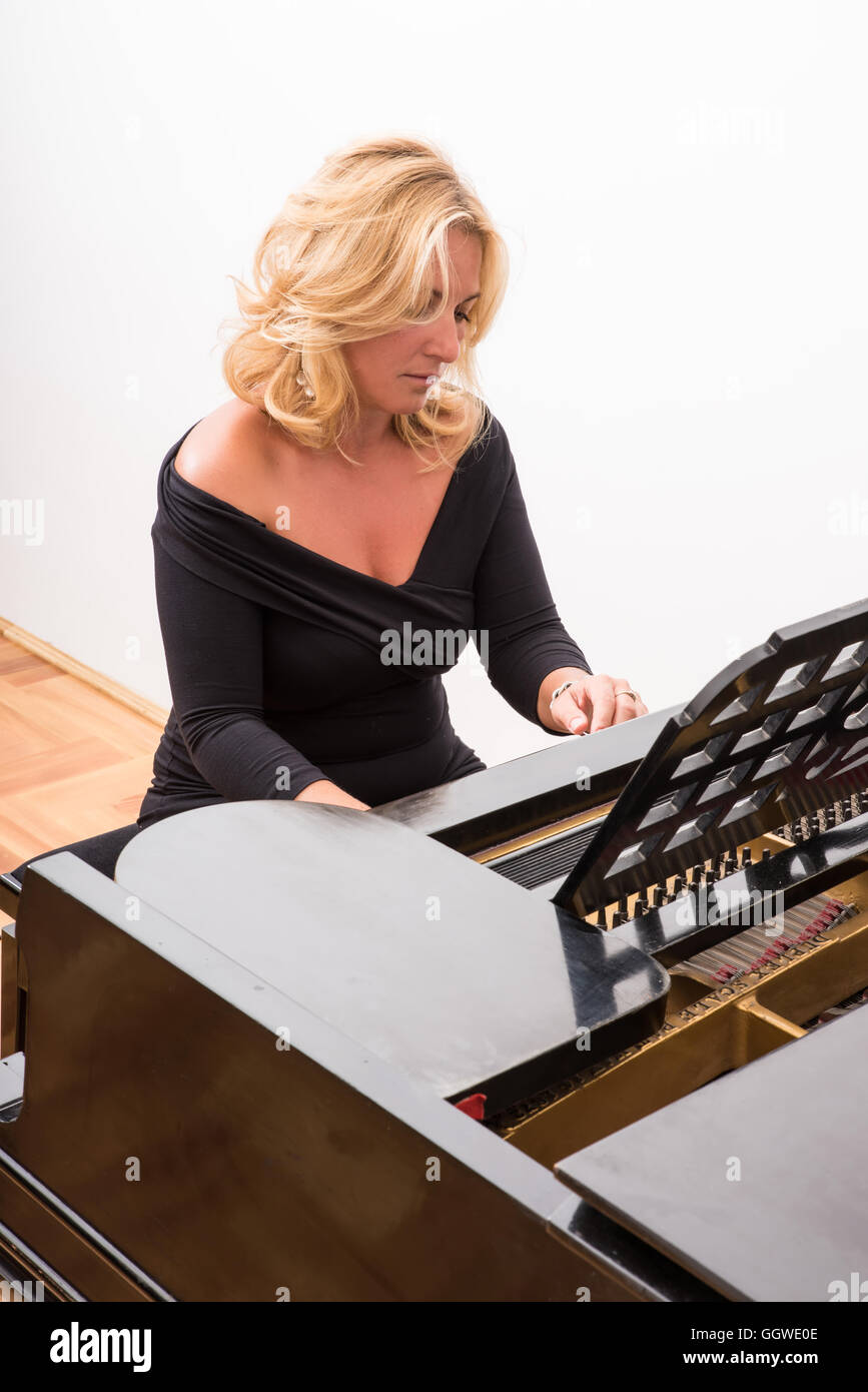 Elegant classical musician woman playing on piano Stock Photo - Alamy