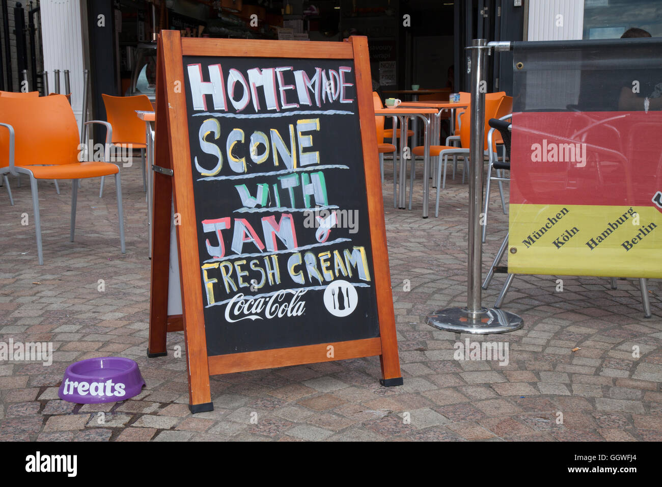 Pavement cafe advertising, & selling homemade scones with jam and cream ...