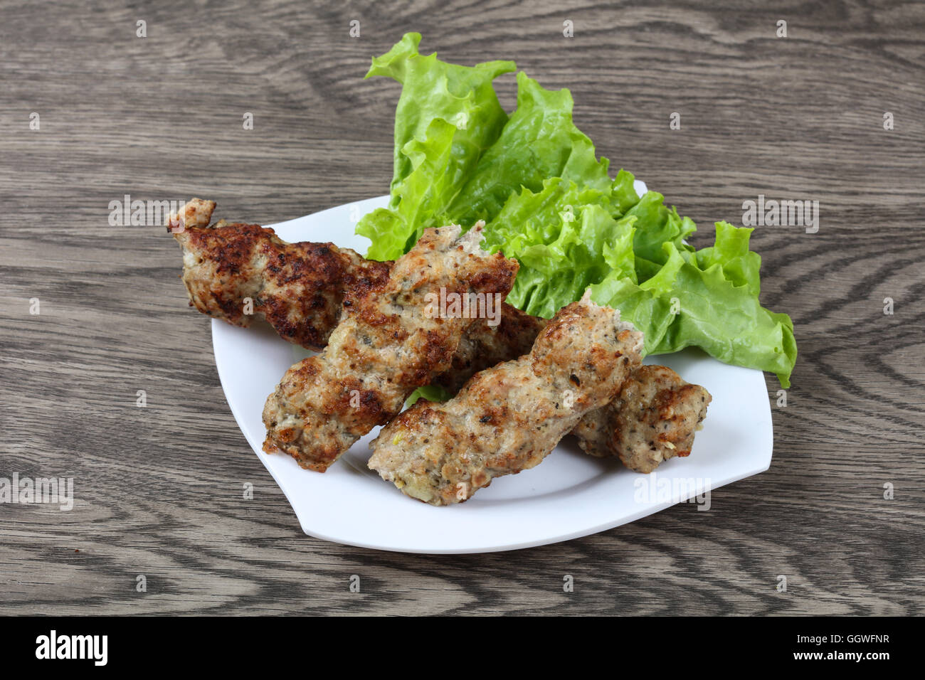 Meat kebab with green salad leaves Stock Photo - Alamy